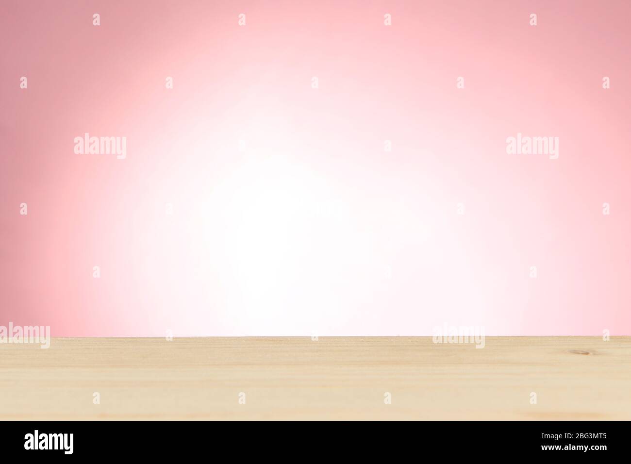 Wooden table on light pink background Stock Photo - Alamy