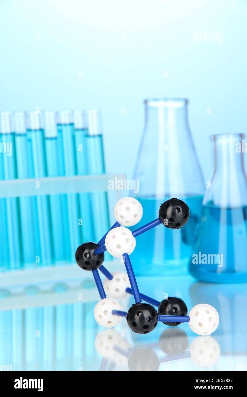 Molecule model and test tubes with liquid on blue background Stock ...