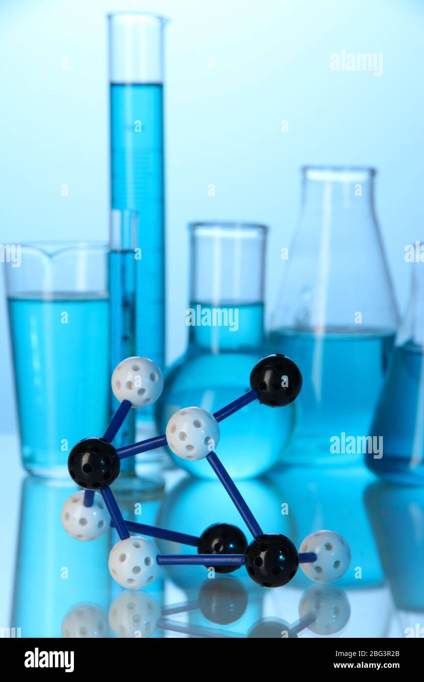 Molecule model and test tubes with liquid on blue background Stock ...