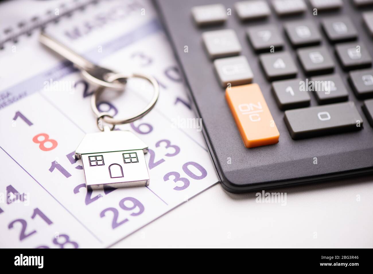 A house key on a calendar background close up Stock Photo - Alamy