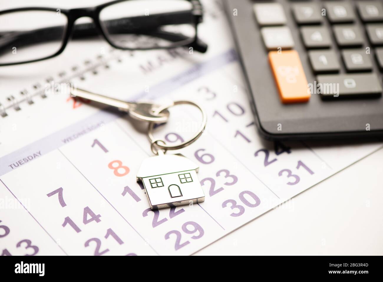 A house key on a calendar background close up Stock Photo - Alamy
