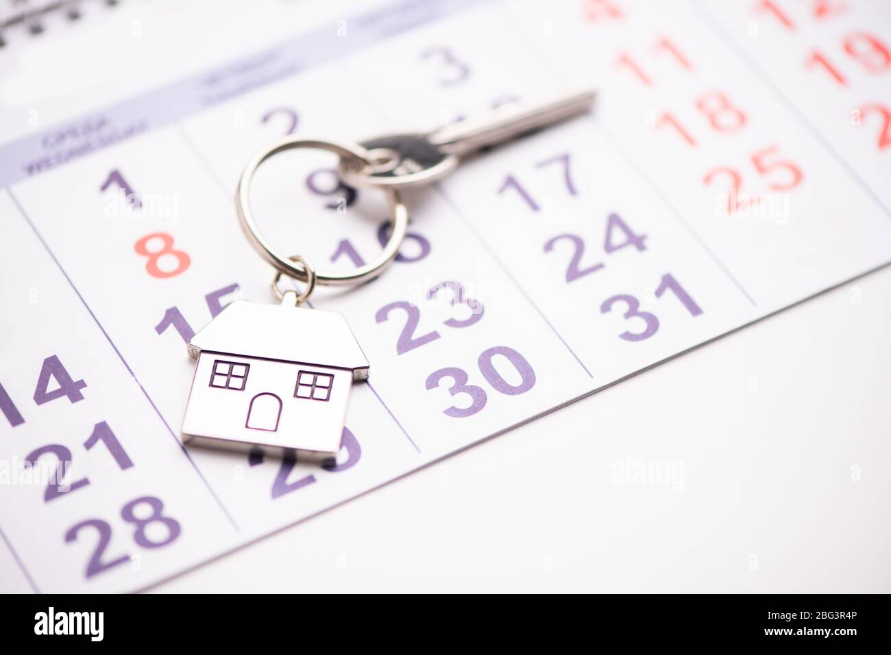 A house key on a calendar background close up Stock Photo - Alamy