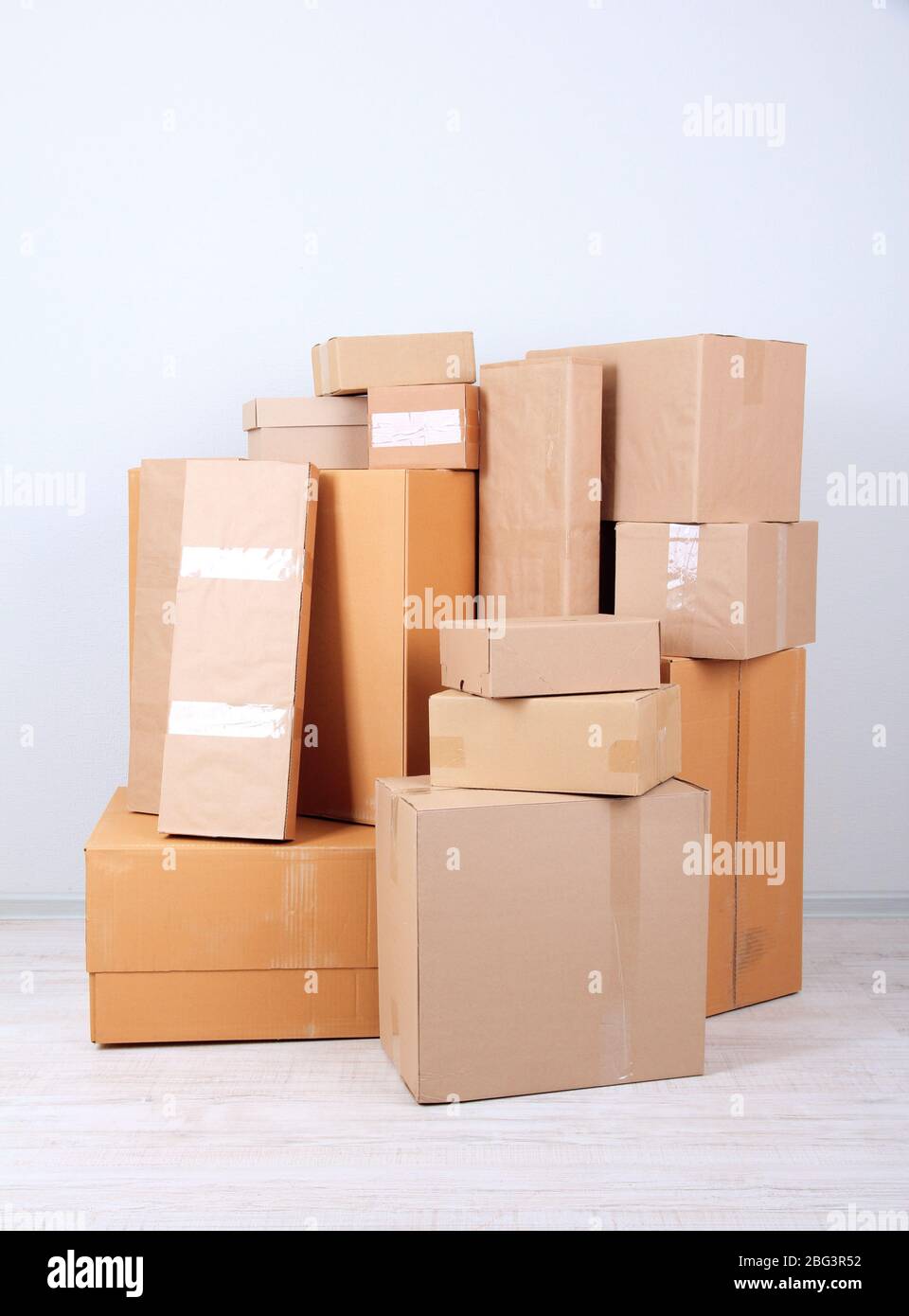 Different cardboard boxes in room Stock Photo - Alamy