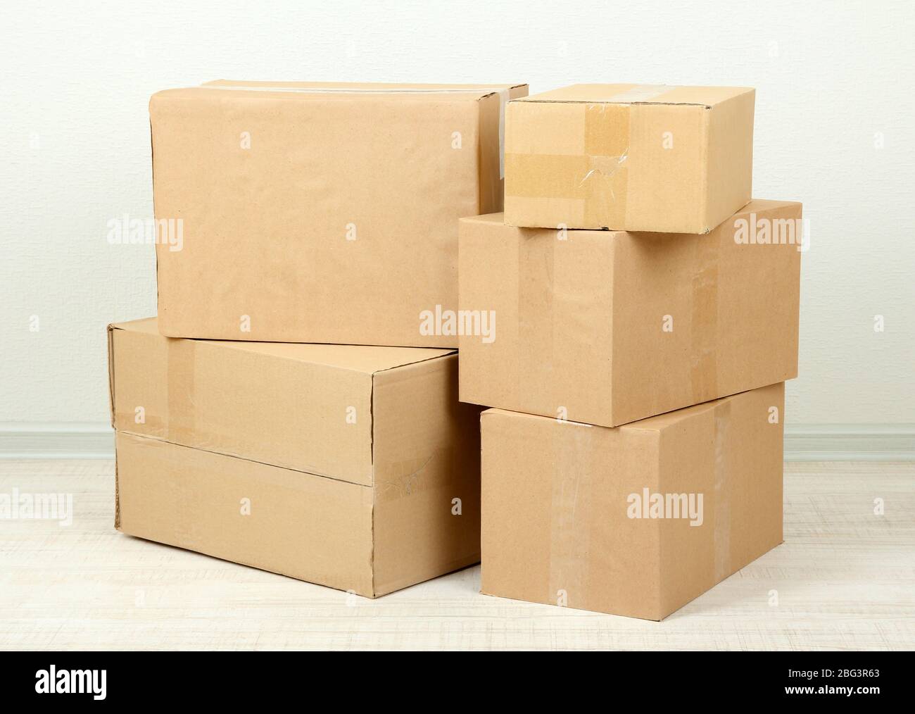 Different cardboard boxes in room Stock Photo - Alamy