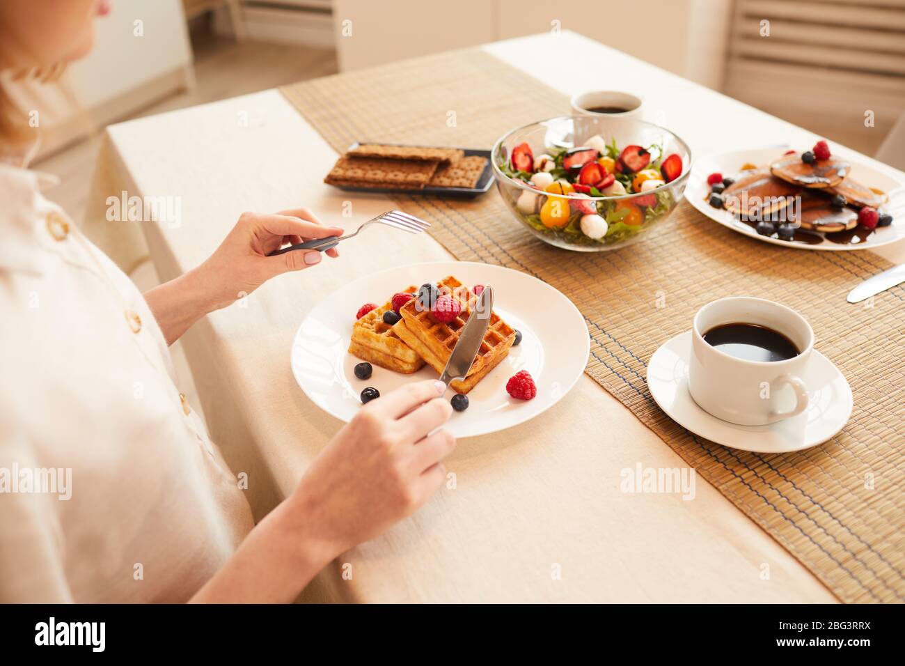 Close up of unrecognizable woman eating delicious dessert while sitting ...