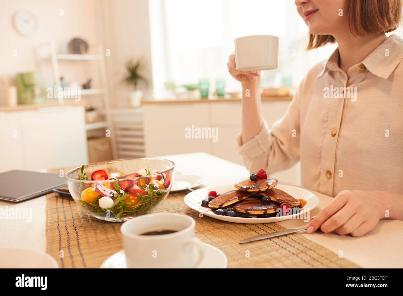 Side view close up of unrecognizable woman enjoying delicious dessert ...