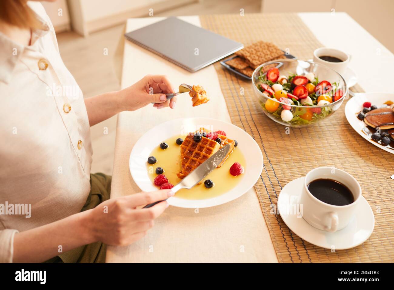 High angle close up of unrecognizable woman enjoying delicious dessert ...