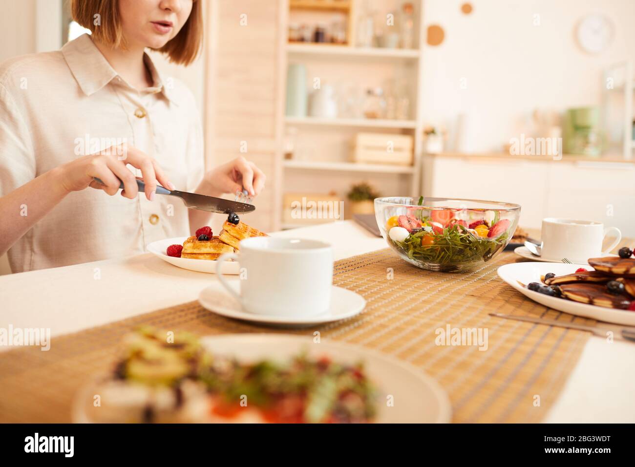 warm toned portrait of unrecognizable woman enjoying delicious dessert ...