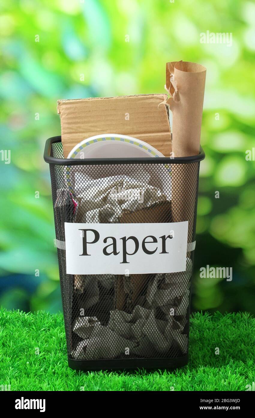 Assorted trash in bucket on nature background Stock Photo - Alamy