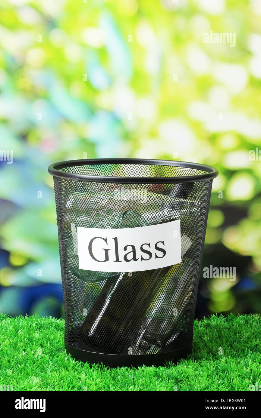 Assorted trash in bucket on nature background Stock Photo - Alamy