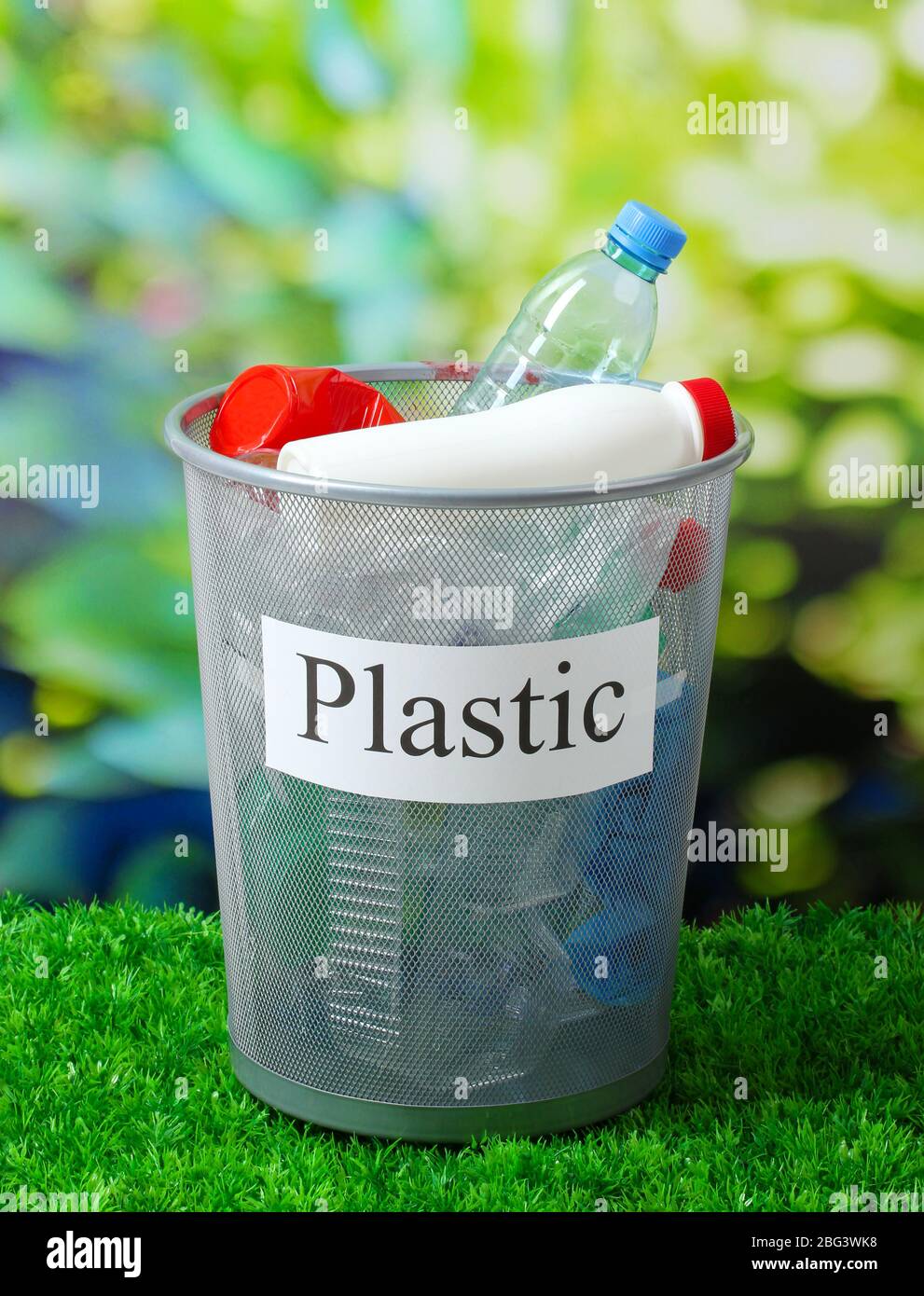 Assorted trash in bucket on nature background Stock Photo - Alamy