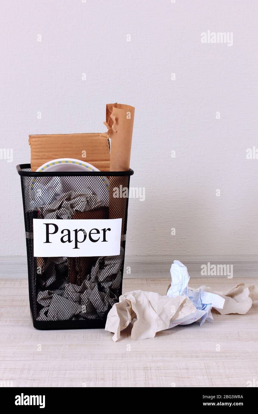 Assorted trash in bucket on room background Stock Photo - Alamy