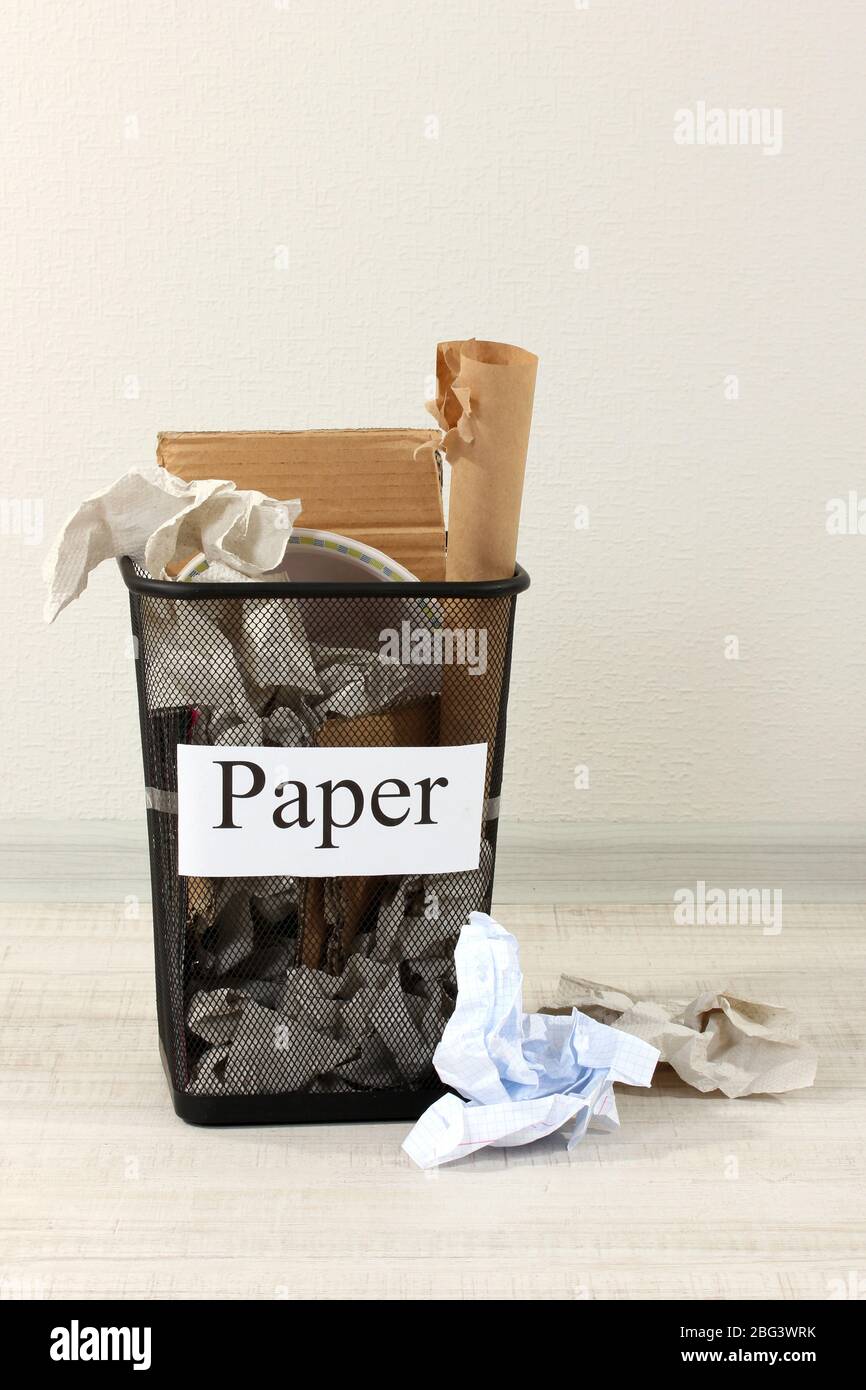 Assorted trash in bucket on room background Stock Photo - Alamy