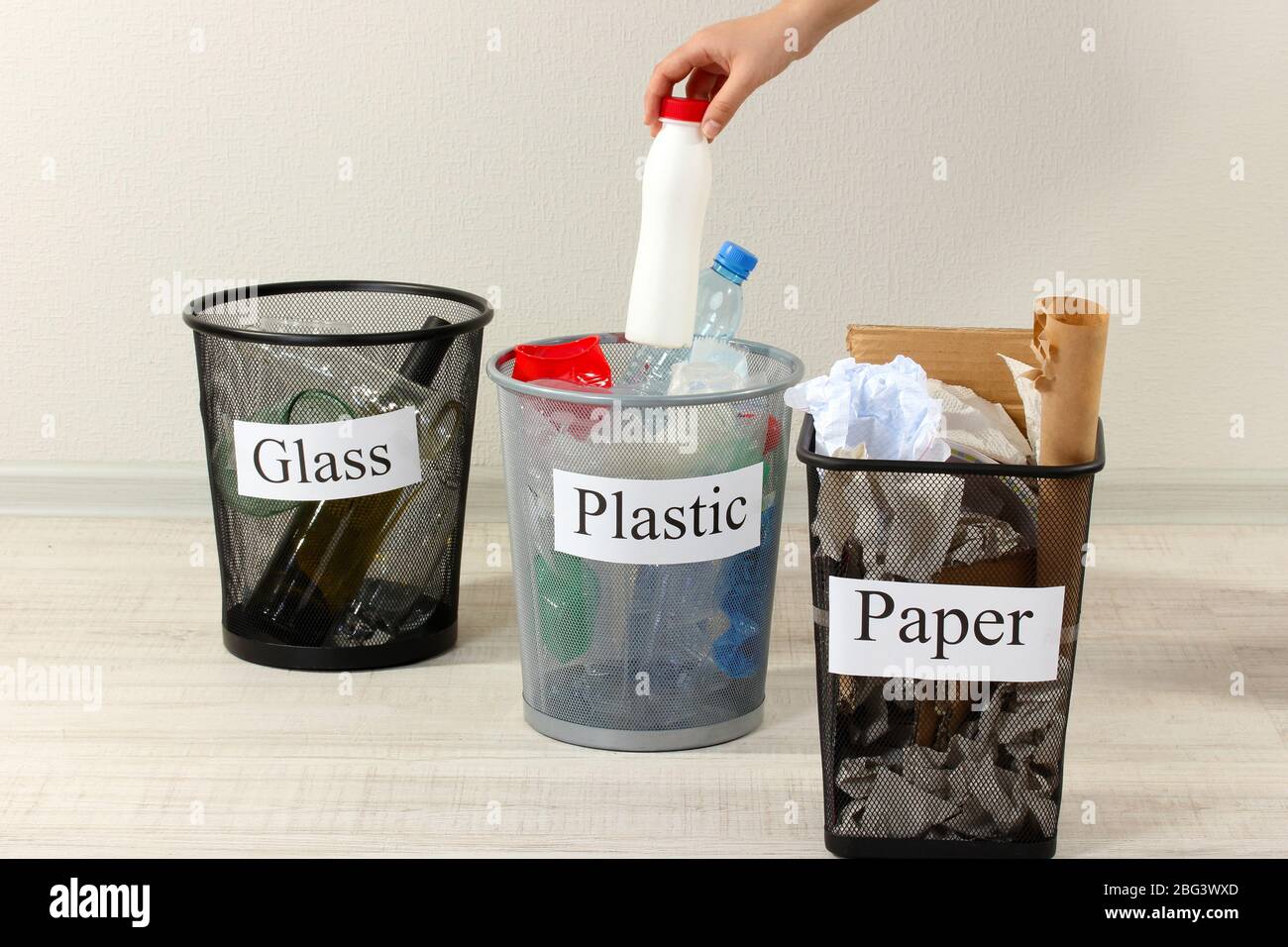Three buckets of assorted debris on room background Stock Photo - Alamy