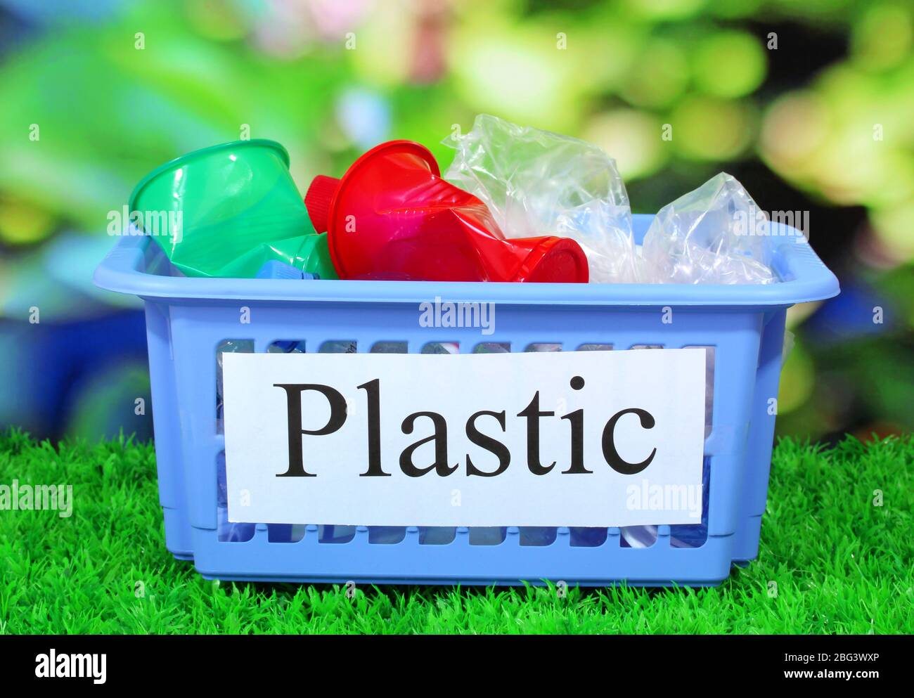 Assorted trash in baskets on nature background Stock Photo - Alamy