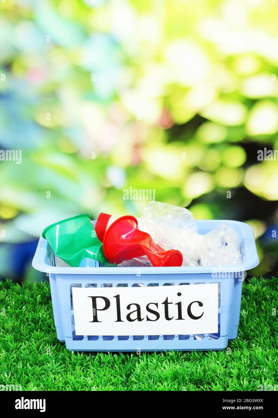 Assorted trash in baskets on nature background Stock Photo - Alamy