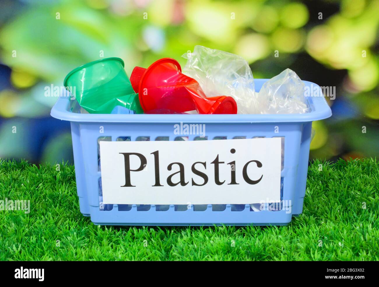 Assorted trash in baskets on nature background Stock Photo - Alamy