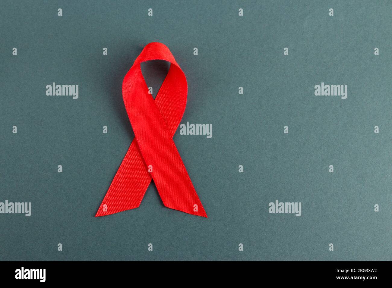 Red ribbon HIV, AIDS on gray background Stock Photo - Alamy