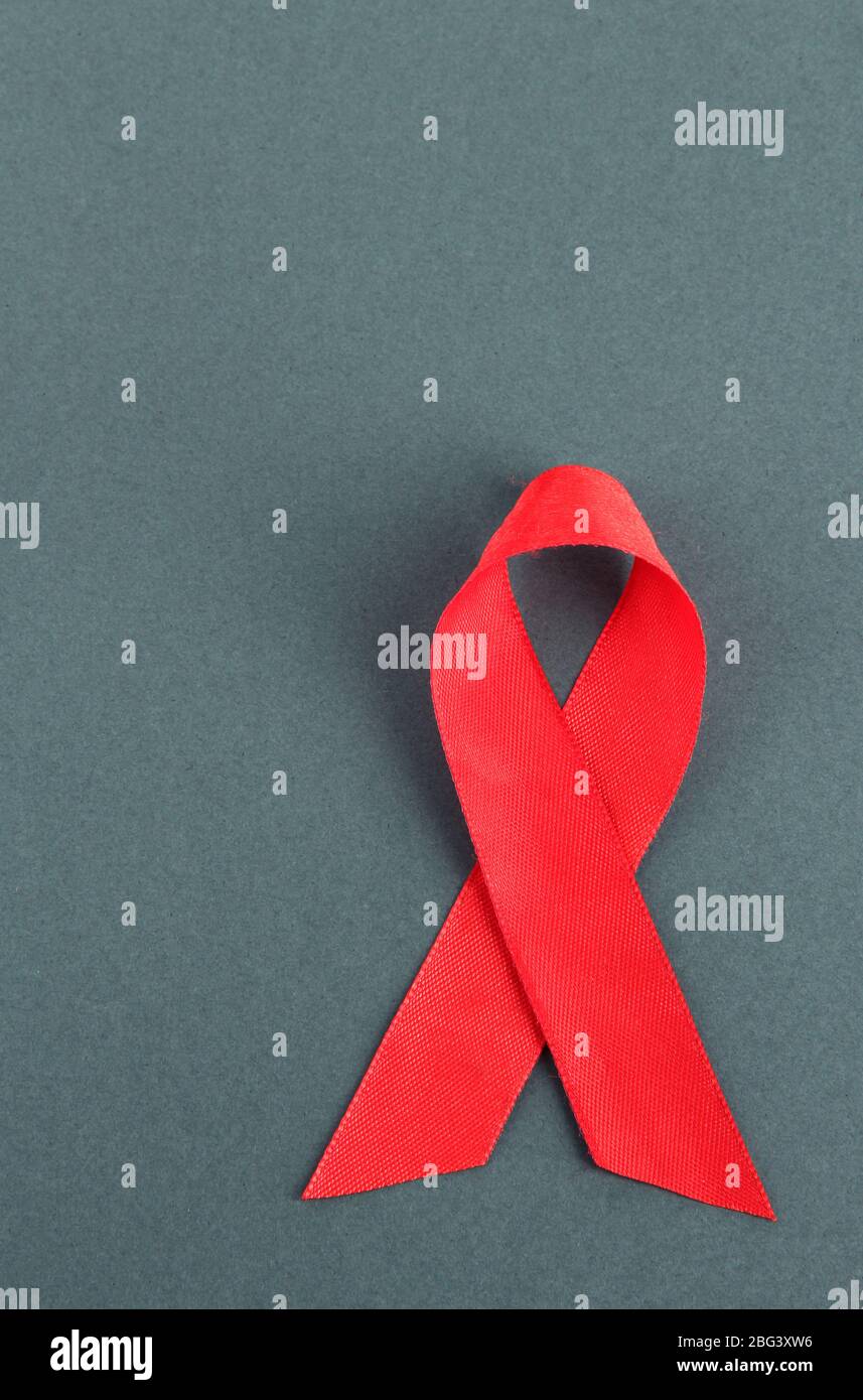 Red ribbon HIV, AIDS on gray background Stock Photo - Alamy