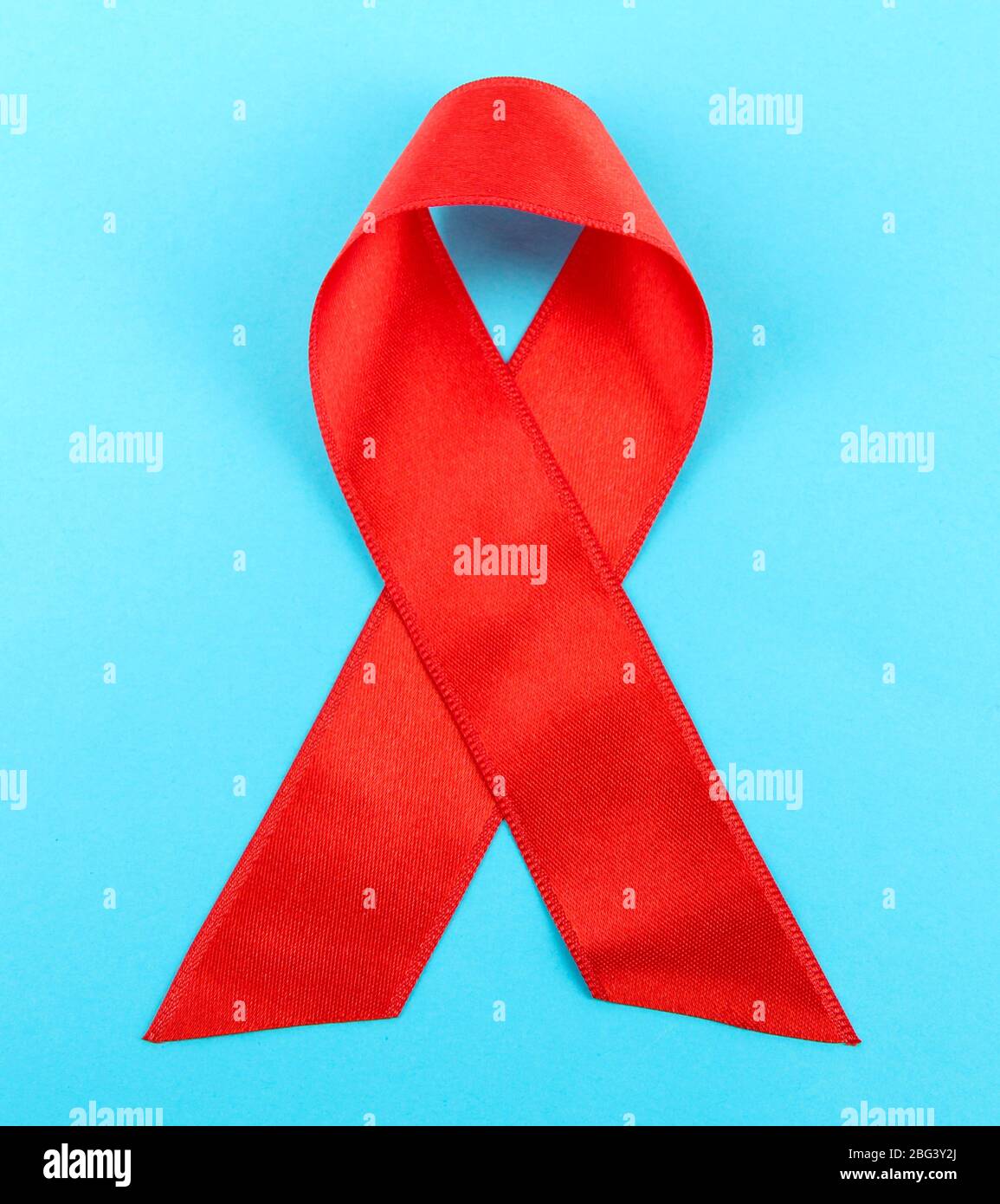 Red ribbon HIV, AIDS on blue background Stock Photo - Alamy