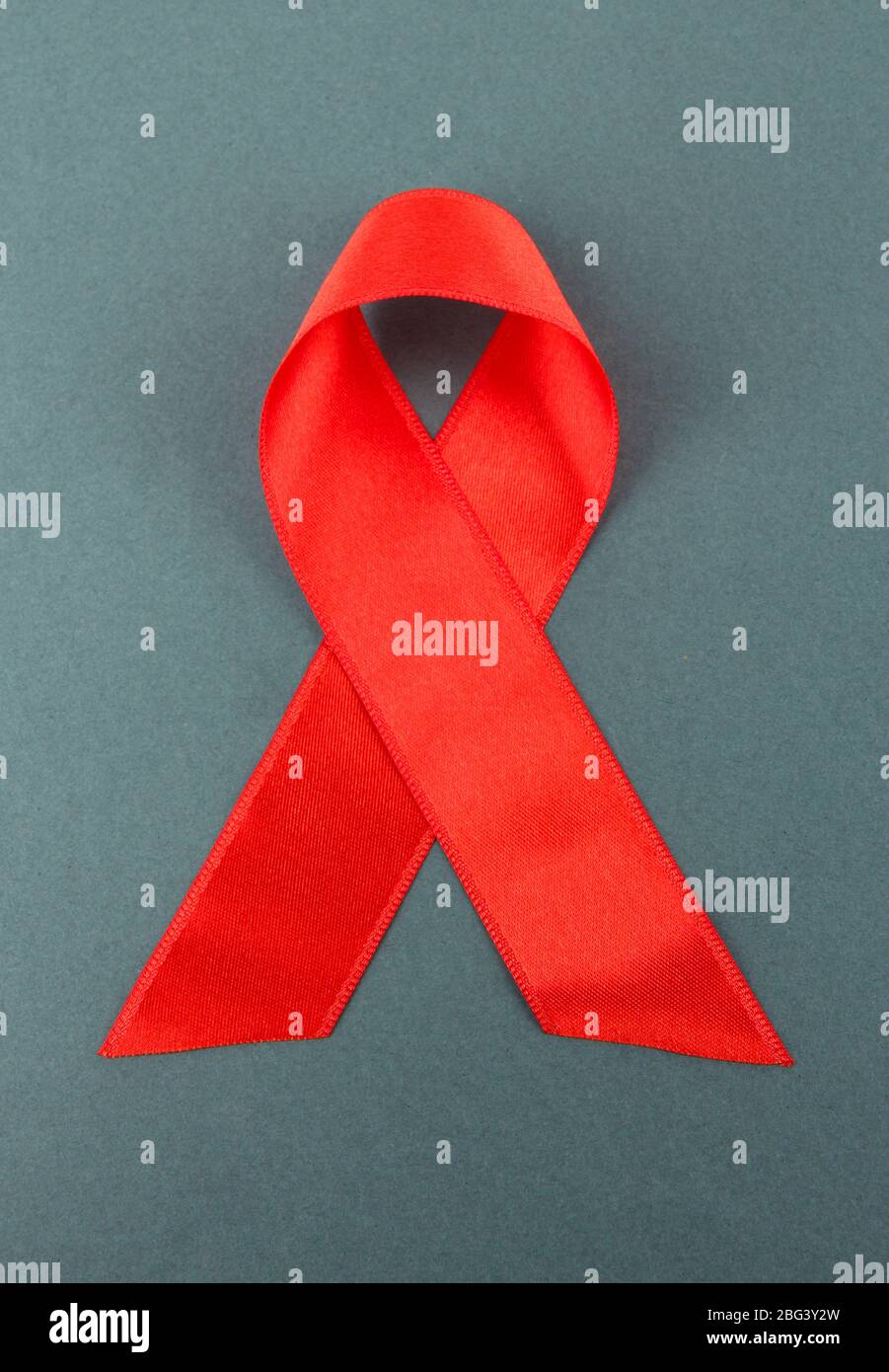 Red ribbon HIV, AIDS on gray background Stock Photo - Alamy