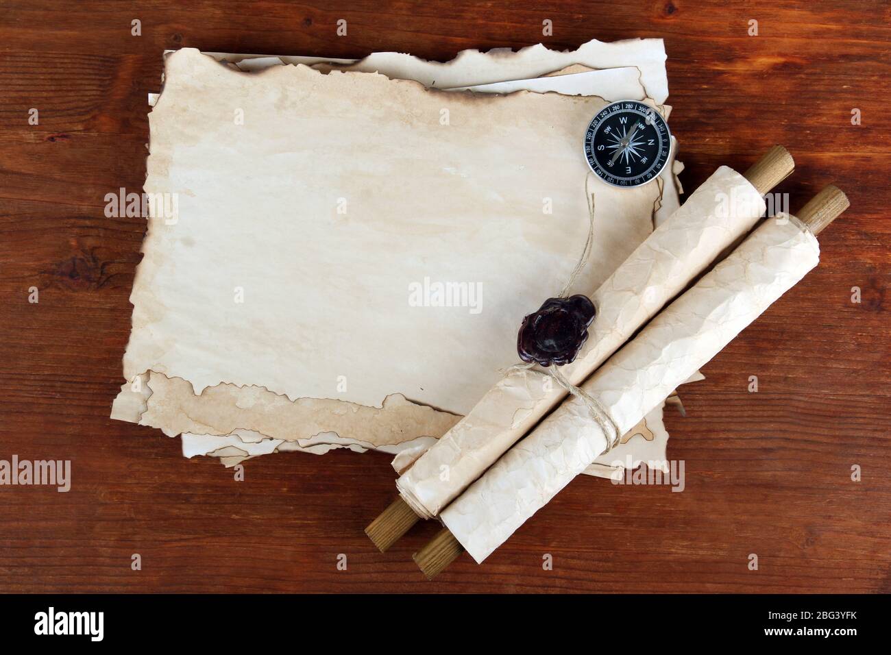 Old paper, scrolls and compass on wooden background Stock Photo - Alamy