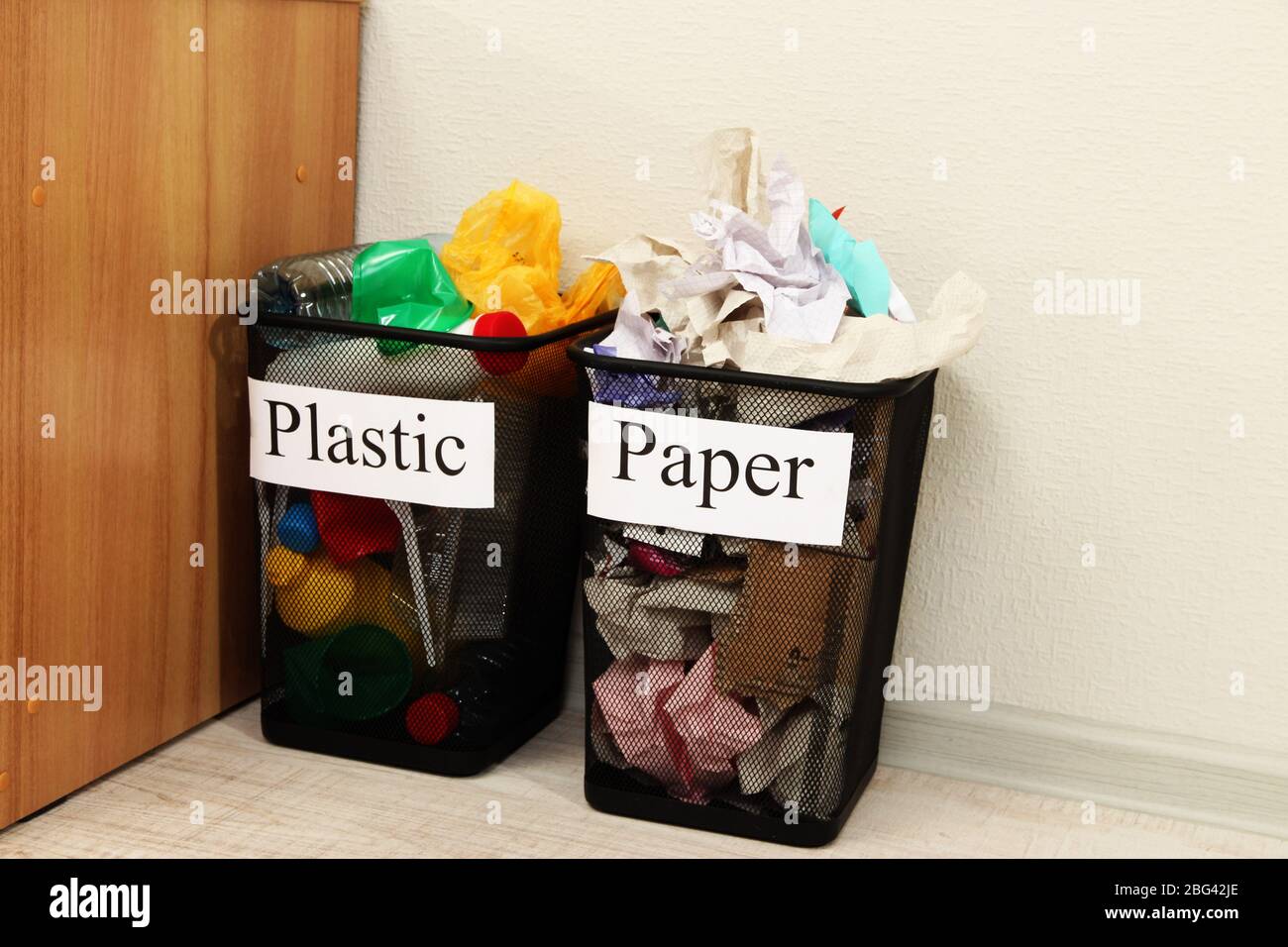 Buckets for waste sorting on room background Stock Photo - Alamy