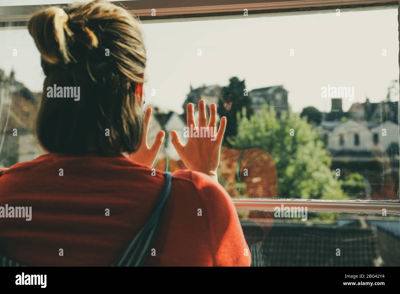 Woman looking through the window with the hands leaning on top Stock ...