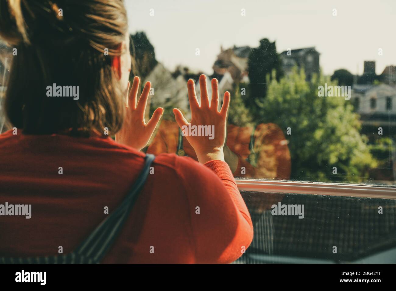 Woman looking through the window with the hands leaning on top Stock ...