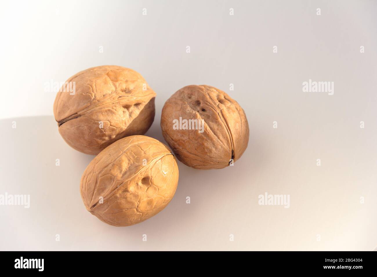Three Walnuts isolated on a white background Stock Photo - Alamy