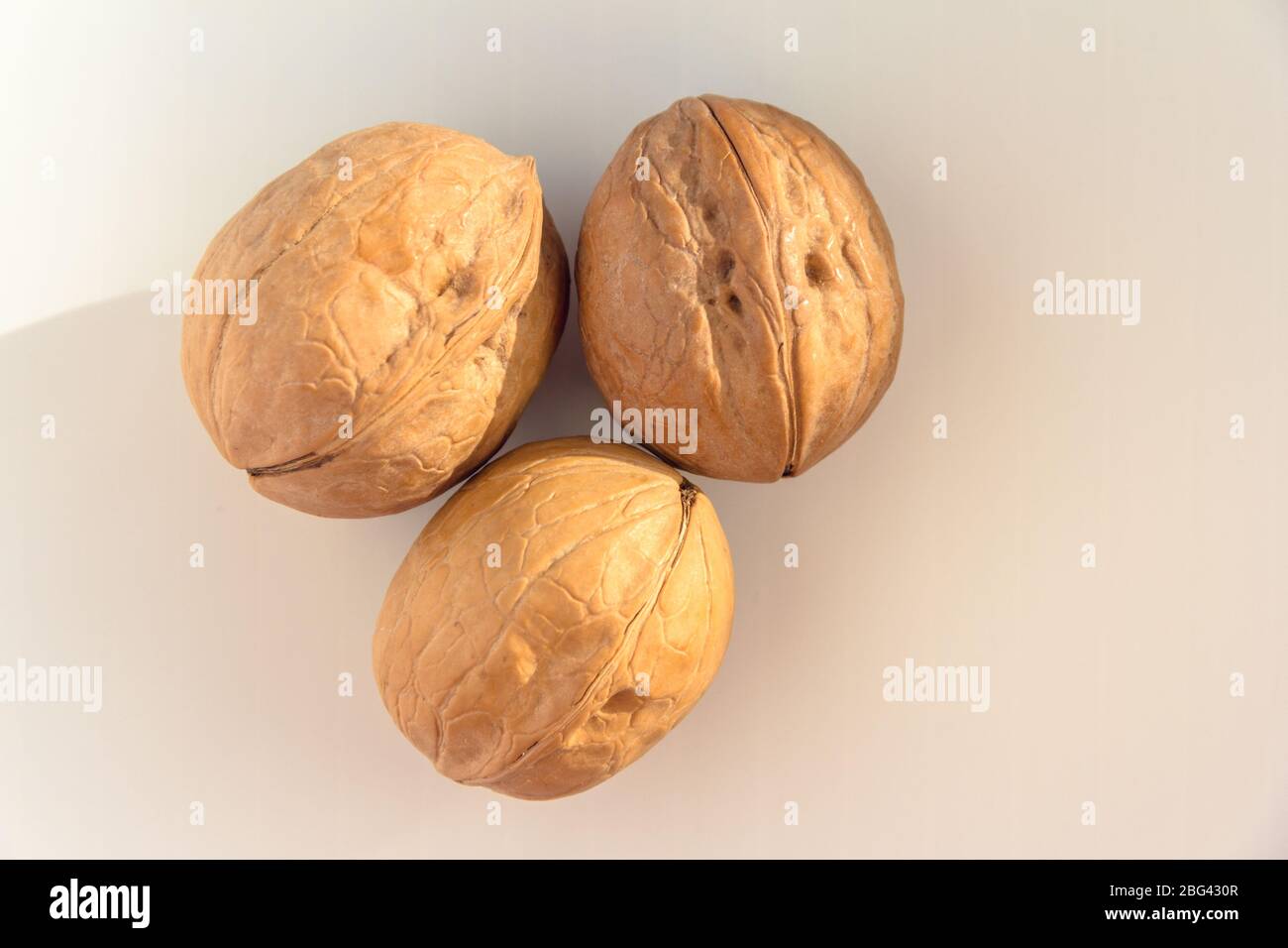Three Walnuts isolated on a white background Stock Photo - Alamy