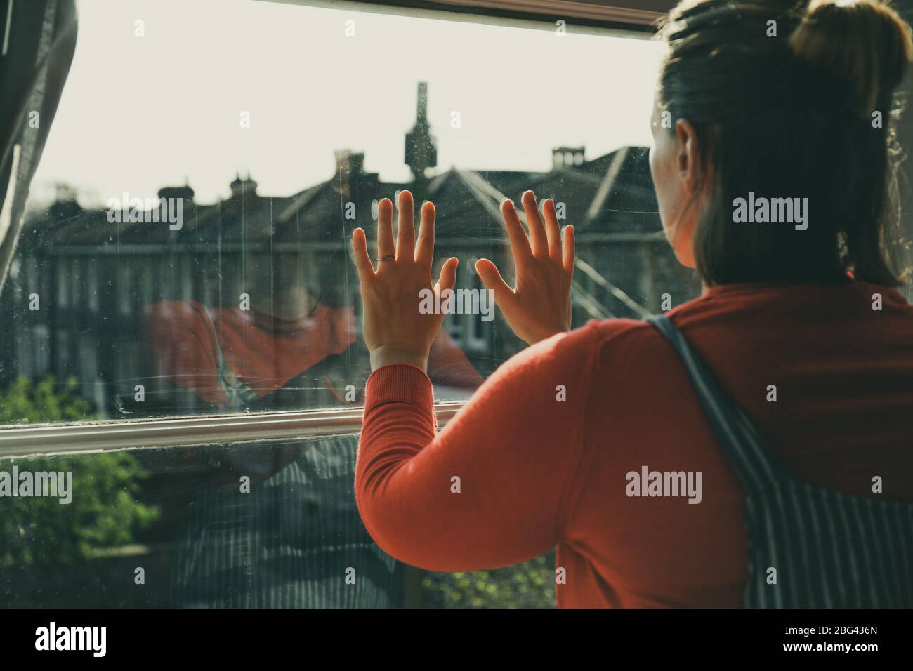 Woman looking through the window with the hands leaning on top Stock ...