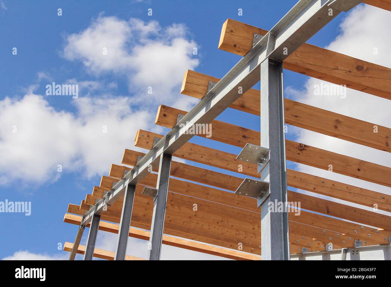 Steel beam structure on new building against the blue sky with clouds ...