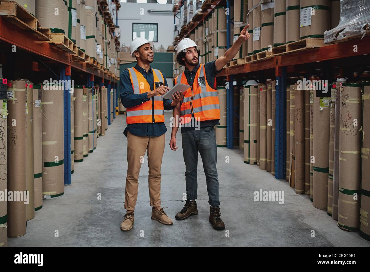 Full length of joyful professional managers working together while ...