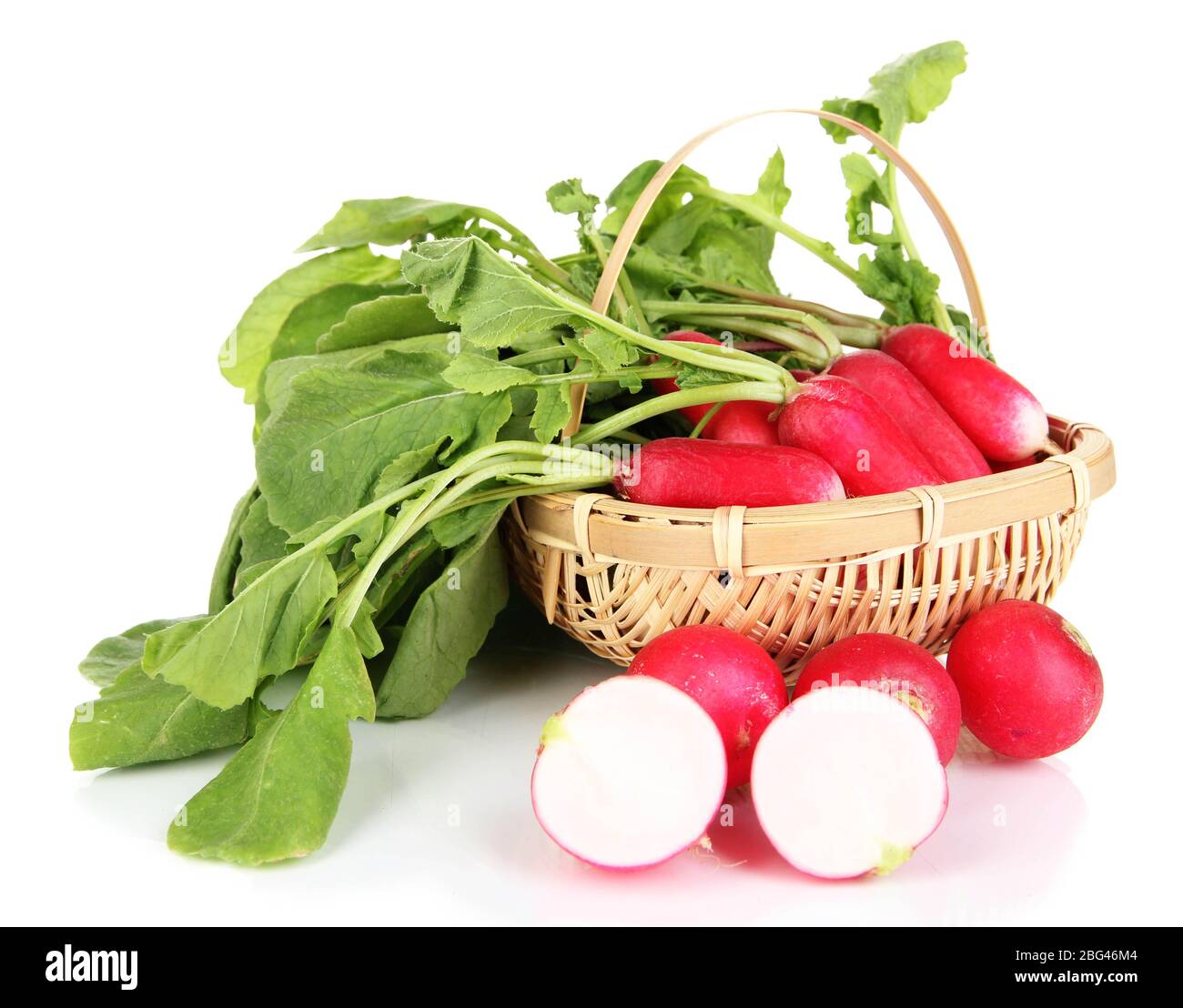 Small garden radish with leaves in wicker basket isolated on white ...