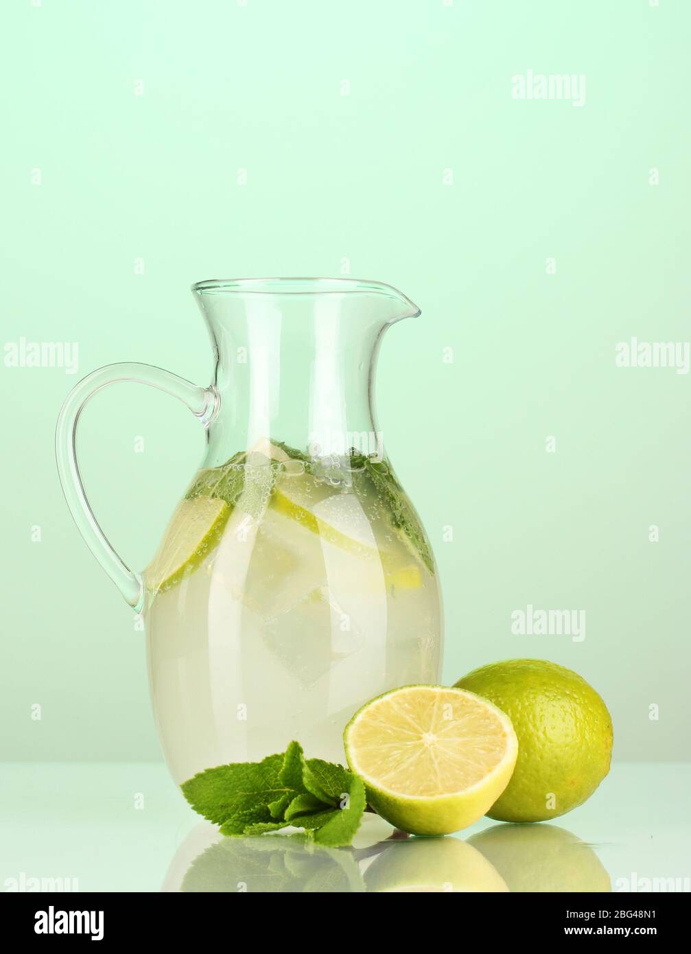 Lemonade in pitcher on turquoise background Stock Photo - Alamy