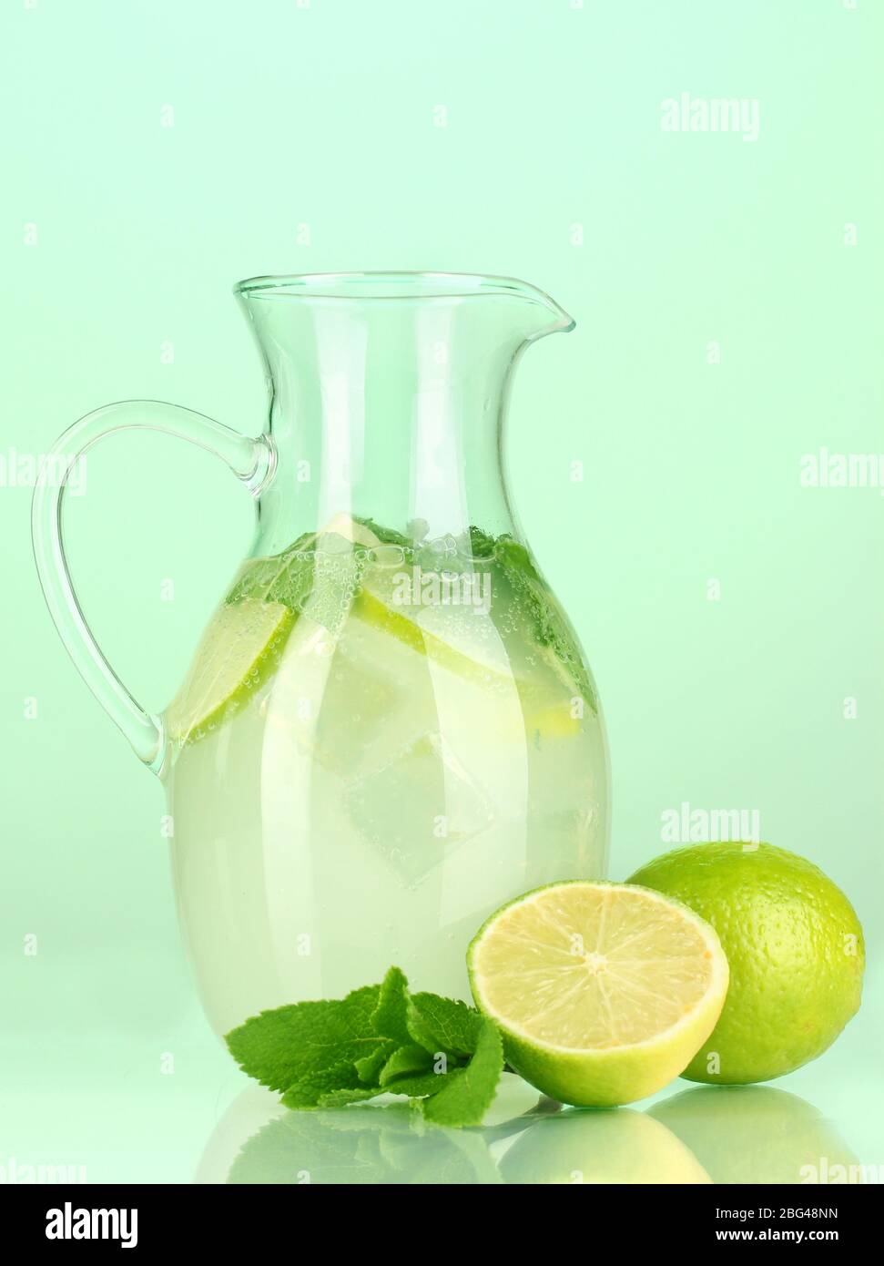 Lemonade in pitcher on turquoise background Stock Photo - Alamy