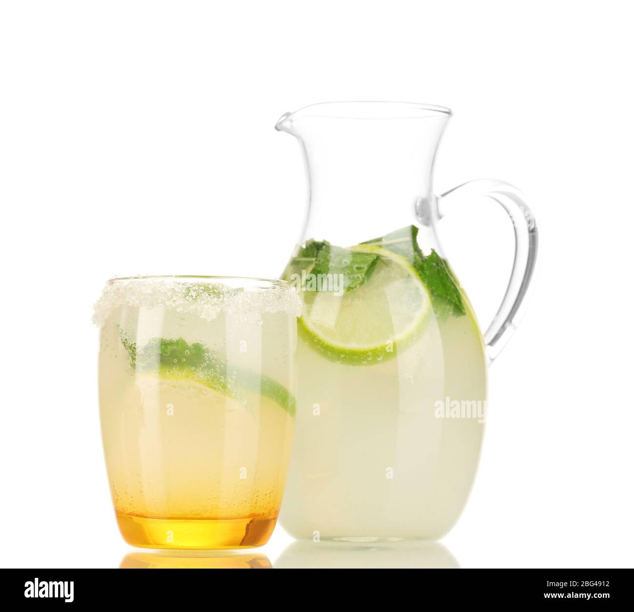Citrus lemonade in pitcher and glass isolated on white Stock Photo - Alamy