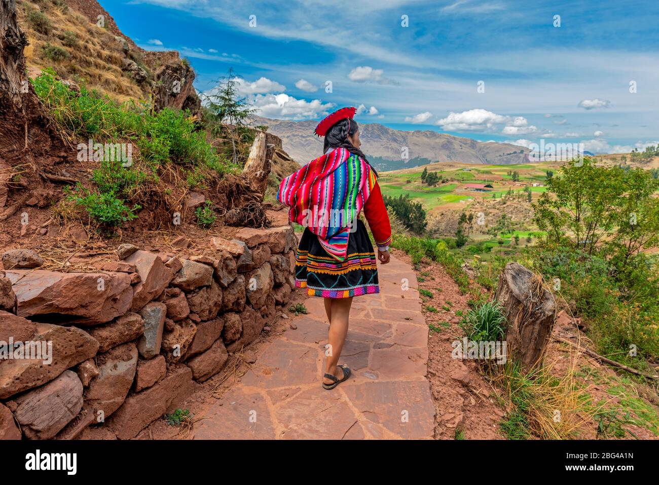 Unrecognizable Quechua Indigenous Woman in traditional clothes walking ...