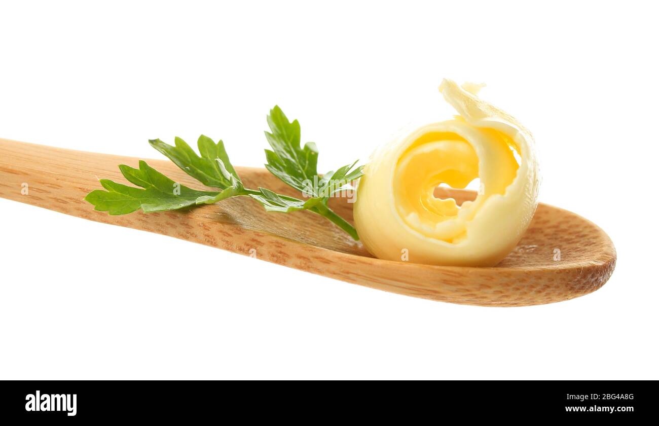 Butter curl on wooden spoon, isolated on white Stock Photo - Alamy