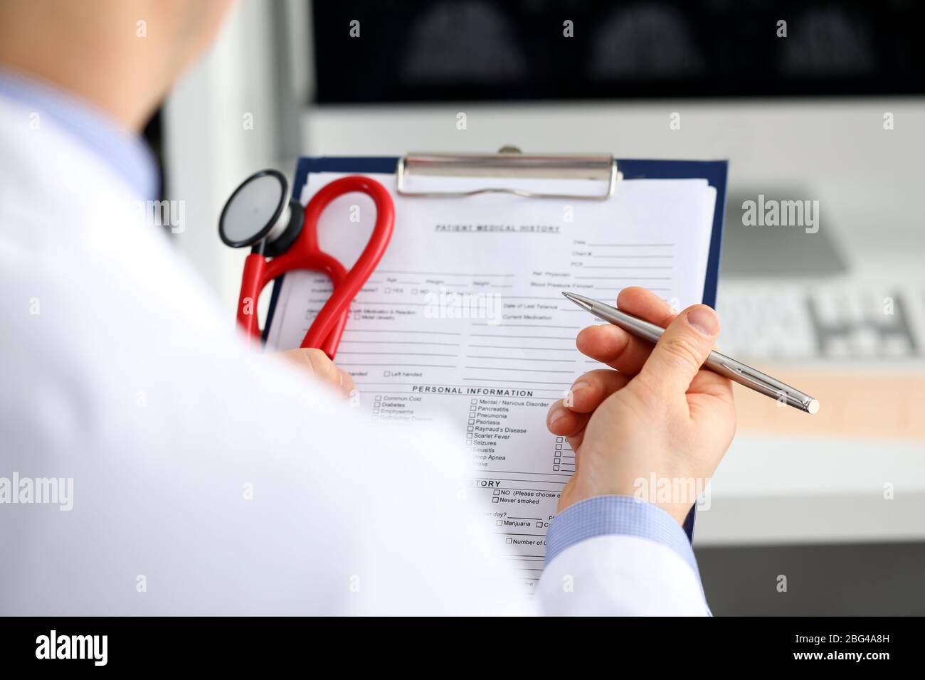 Male physician holding pen hi-res stock photography and images - Alamy