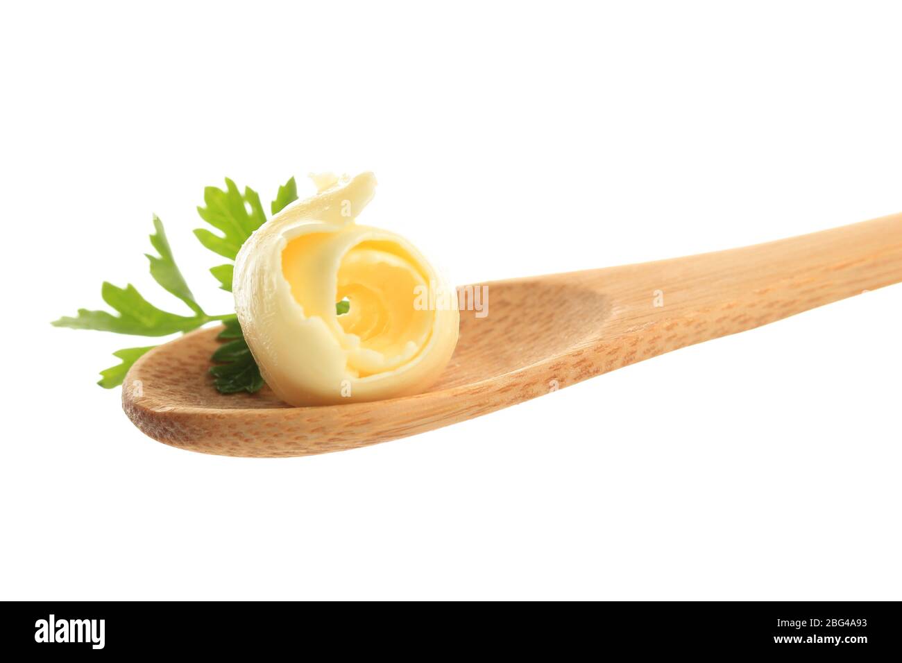 Butter curl on wooden spoon, isolated on white Stock Photo - Alamy