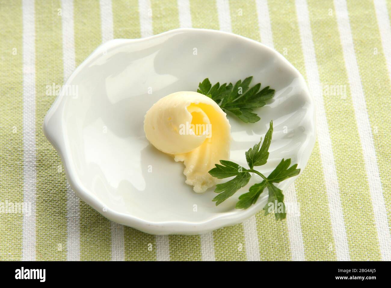 Butter curl on plate, close up Stock Photo - Alamy