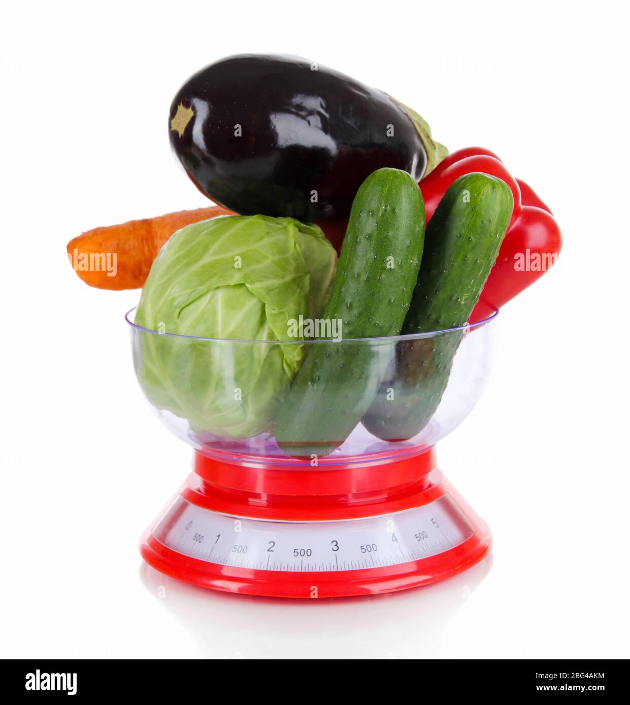 Fresh vegetables in scales isolated on white Stock Photo - Alamy