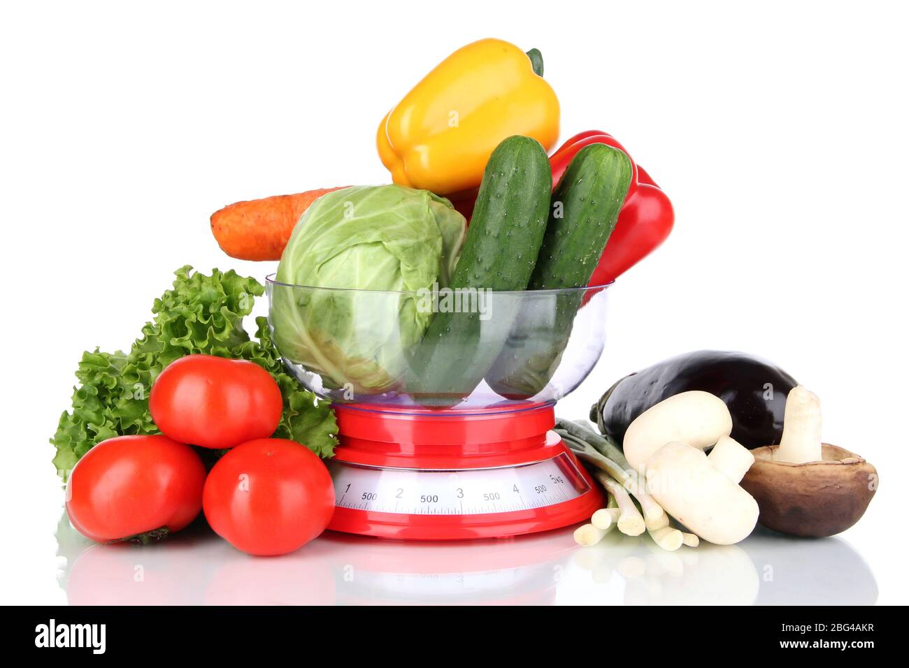 Fresh vegetables in scales isolated on white Stock Photo - Alamy