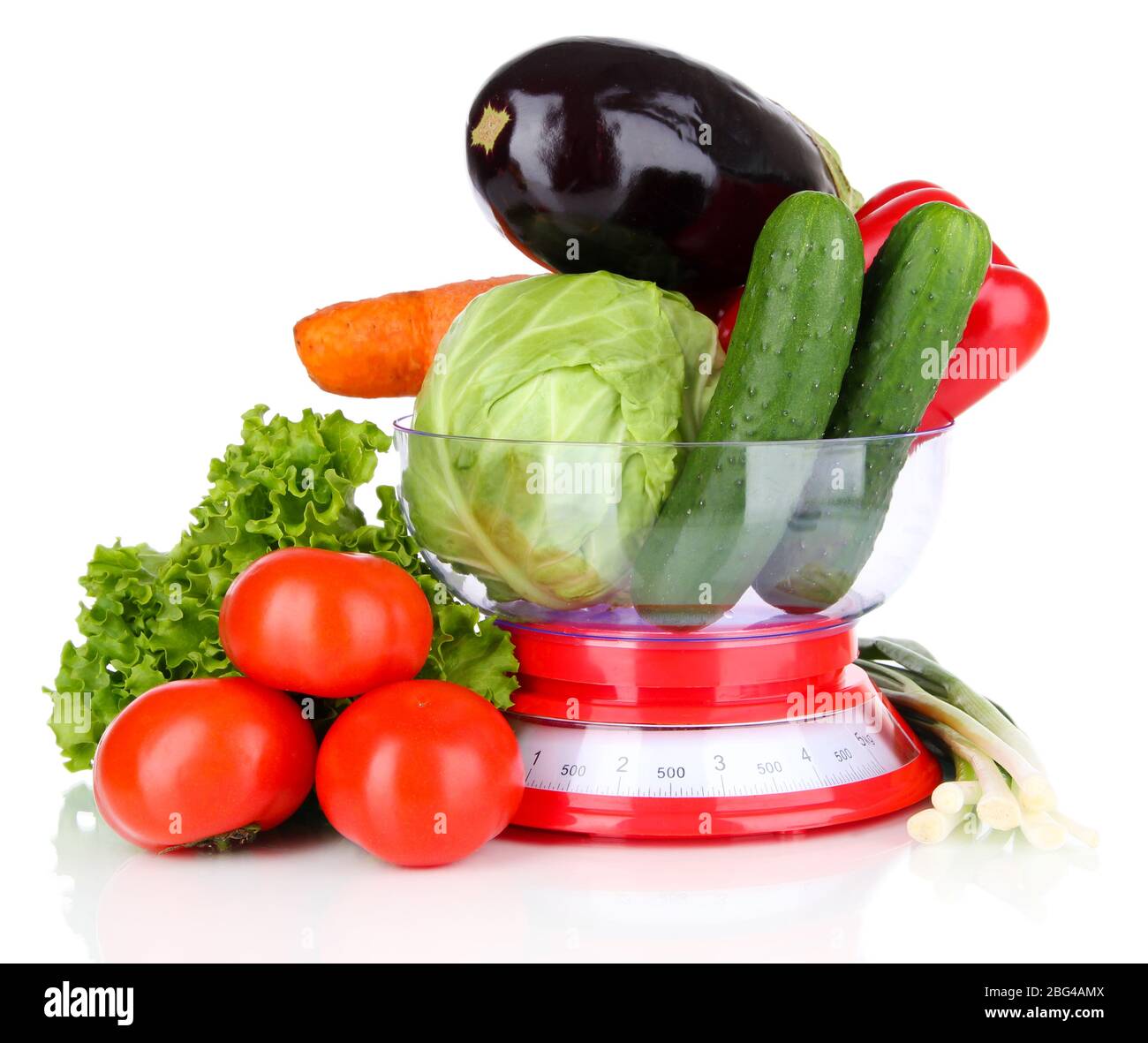Fresh vegetables in scales isolated on white Stock Photo - Alamy