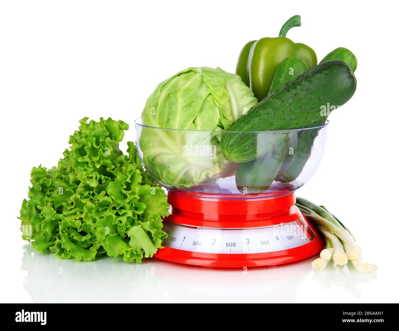 Fresh vegetables in scales isolated on white Stock Photo - Alamy