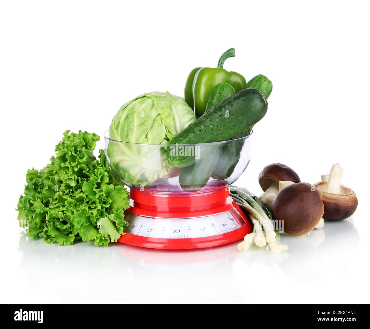 Fresh vegetables in scales isolated on white Stock Photo - Alamy