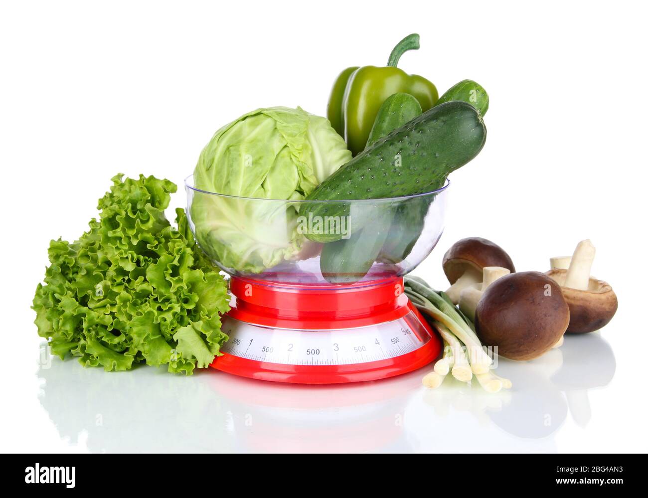 Fresh vegetables in scales isolated on white Stock Photo - Alamy