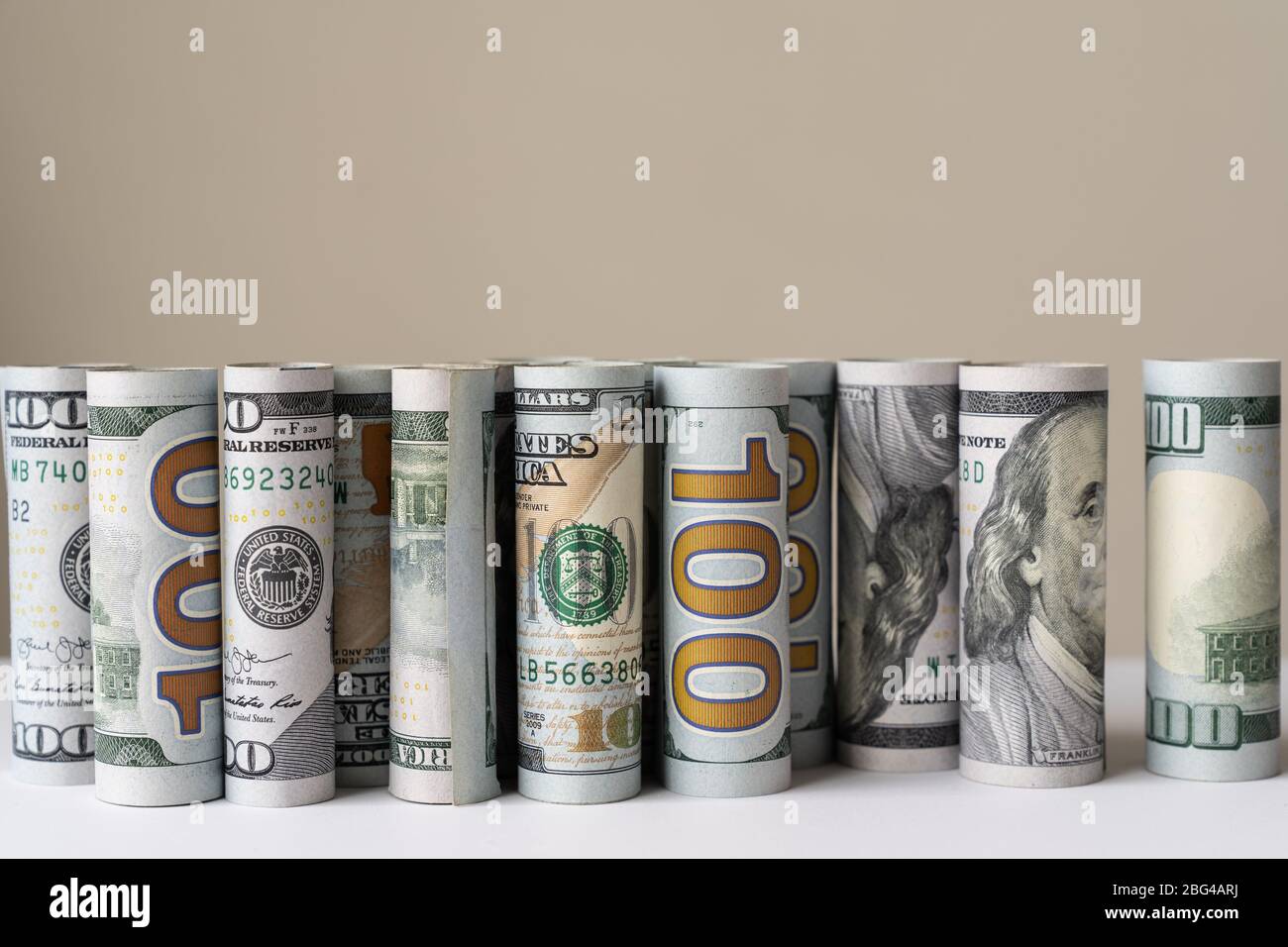 Rolls of US dollar bill in a row Stock Photo - Alamy